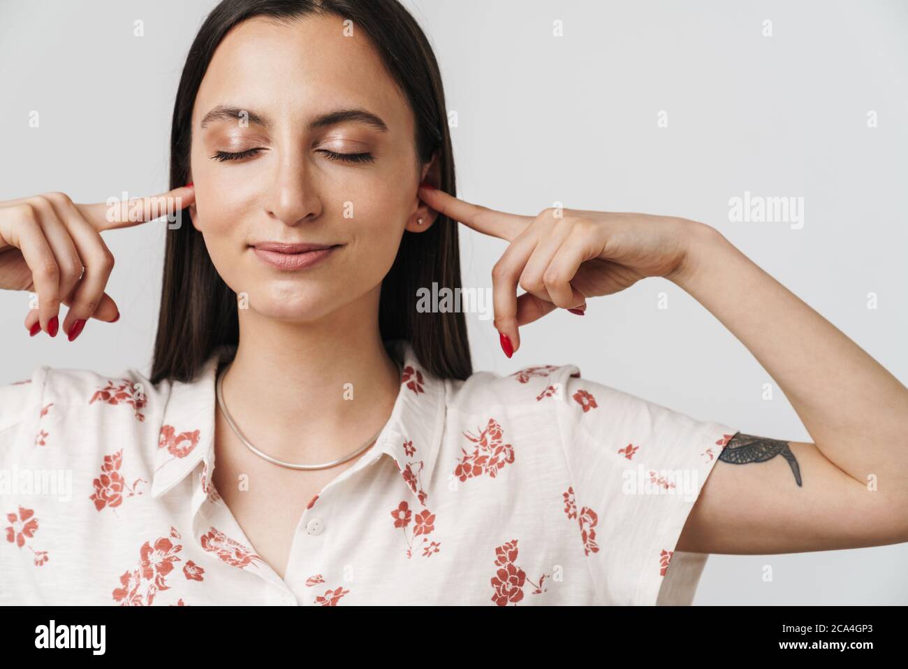 Photo of joyful beautiful woman plugging his ears and smiling isolated ...