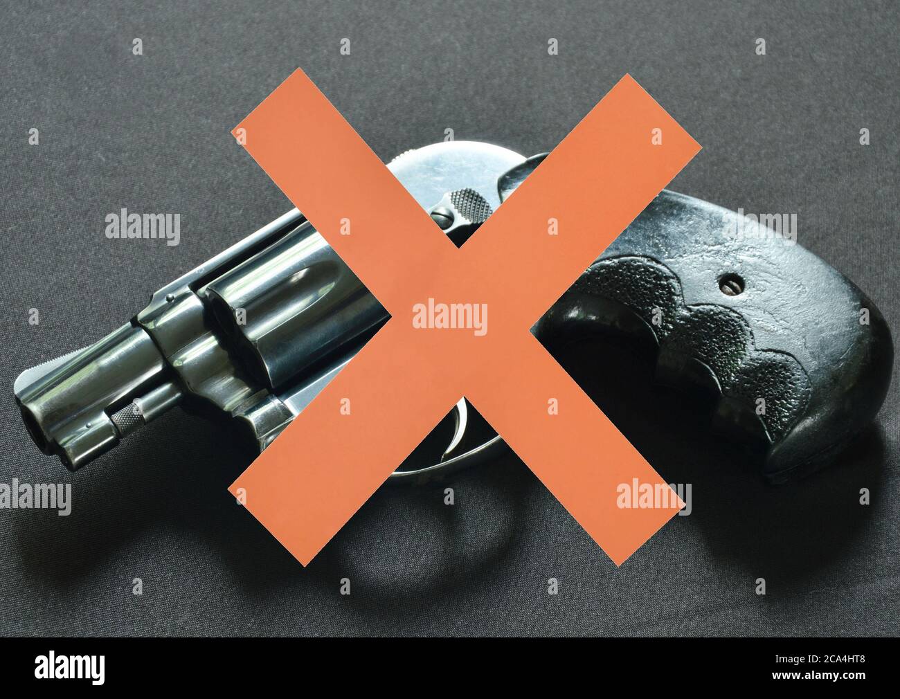 red cross in front of revolver for anti gun violence and crime Stock ...