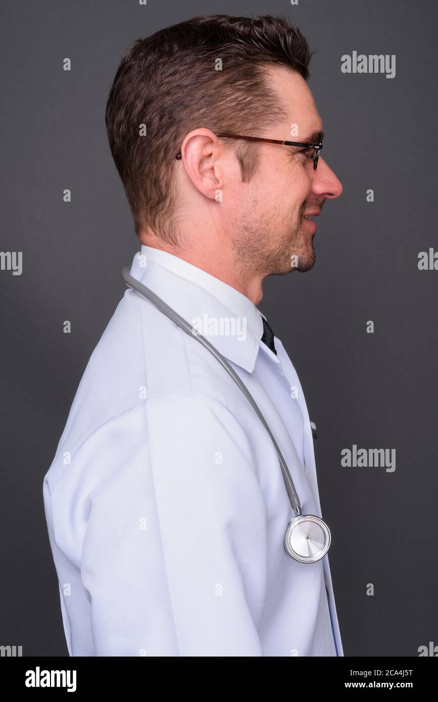 Portrait of happy handsome bearded man doctor Stock Photo - Alamy