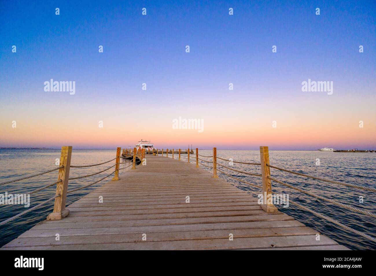 Wooden Pier on Red Sea in Hurghada at sunset and luxury yacht, View of ...