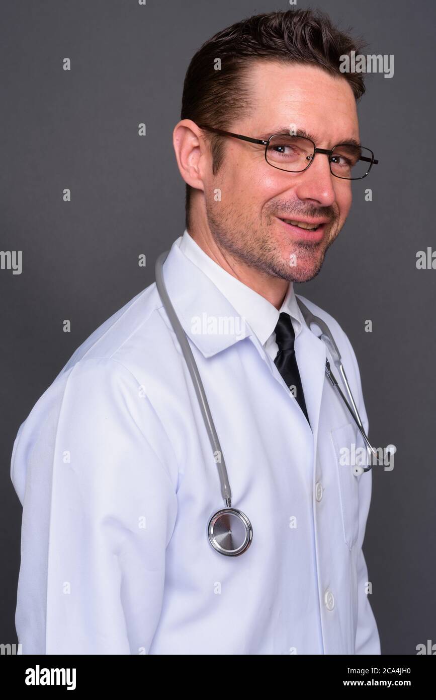 Portrait of happy handsome bearded man doctor Stock Photo - Alamy