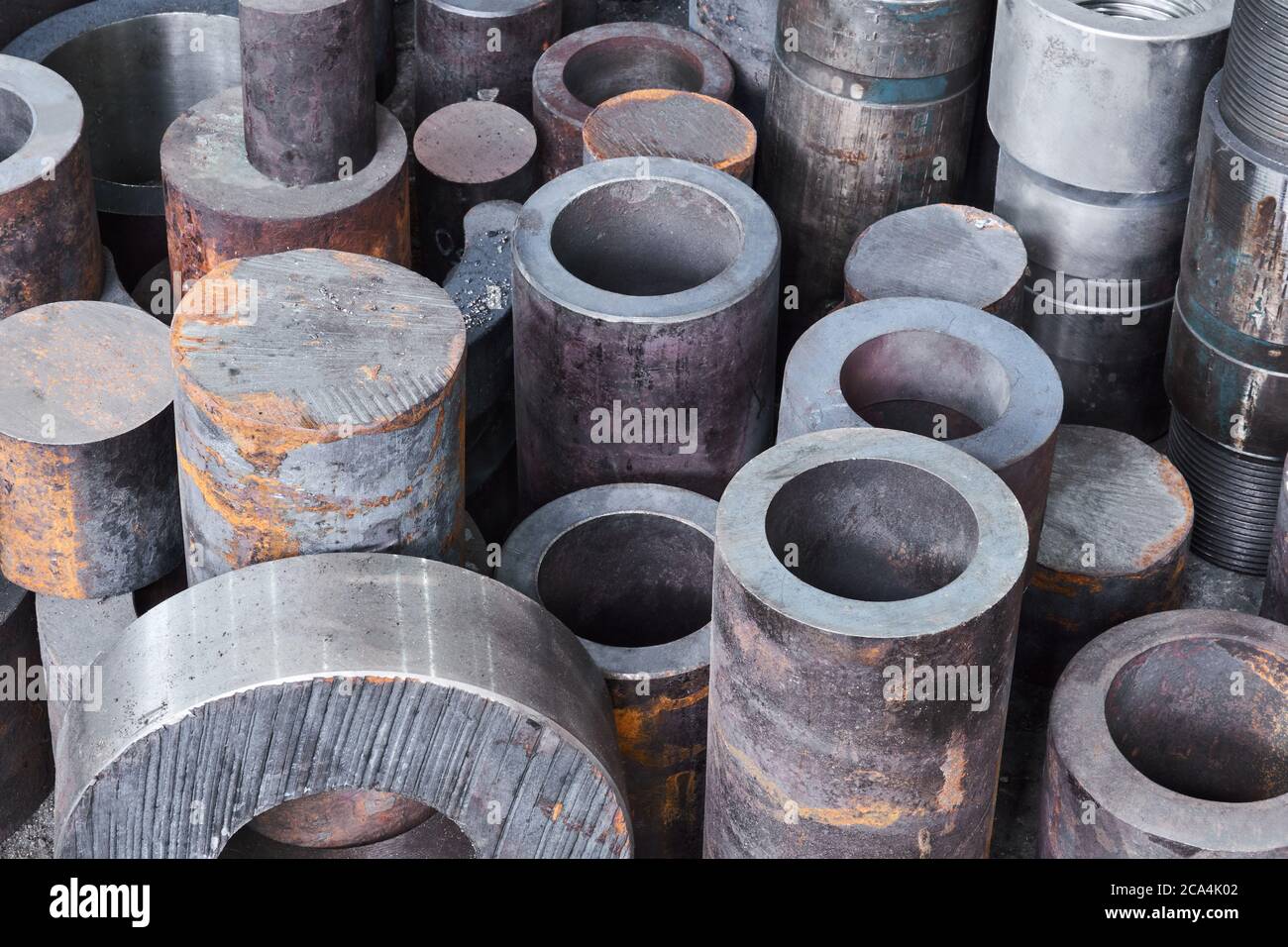 industrial background - rusty hardware, blanks for drill string parts ...