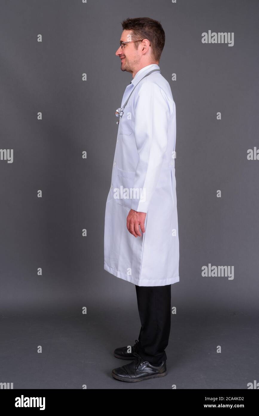 Portrait of happy handsome bearded man doctor Stock Photo - Alamy