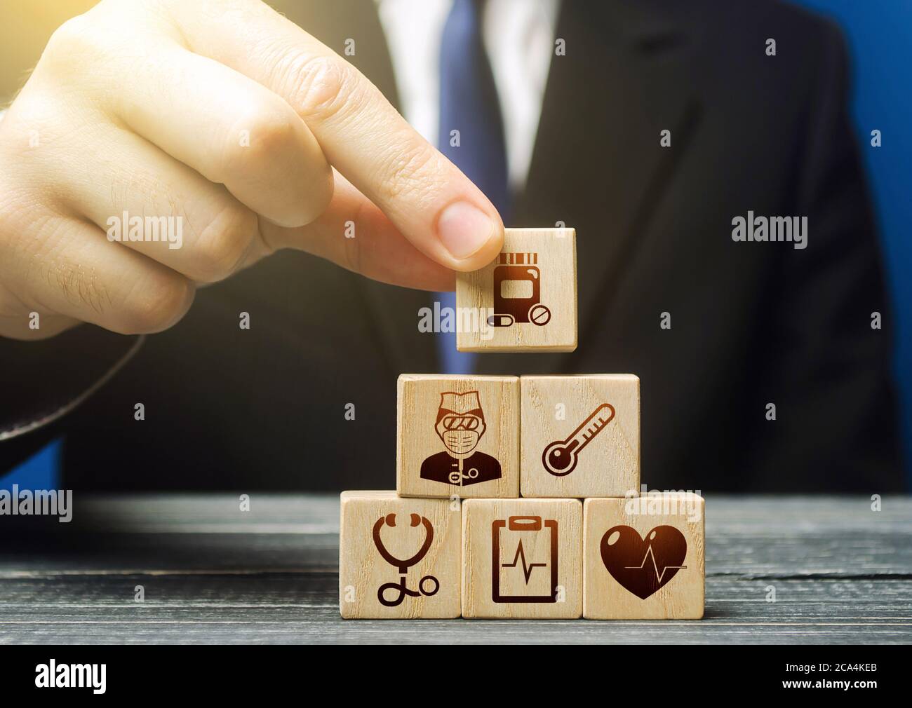Man builds a block pyramid with medical icons symbols. Healthcare and ...