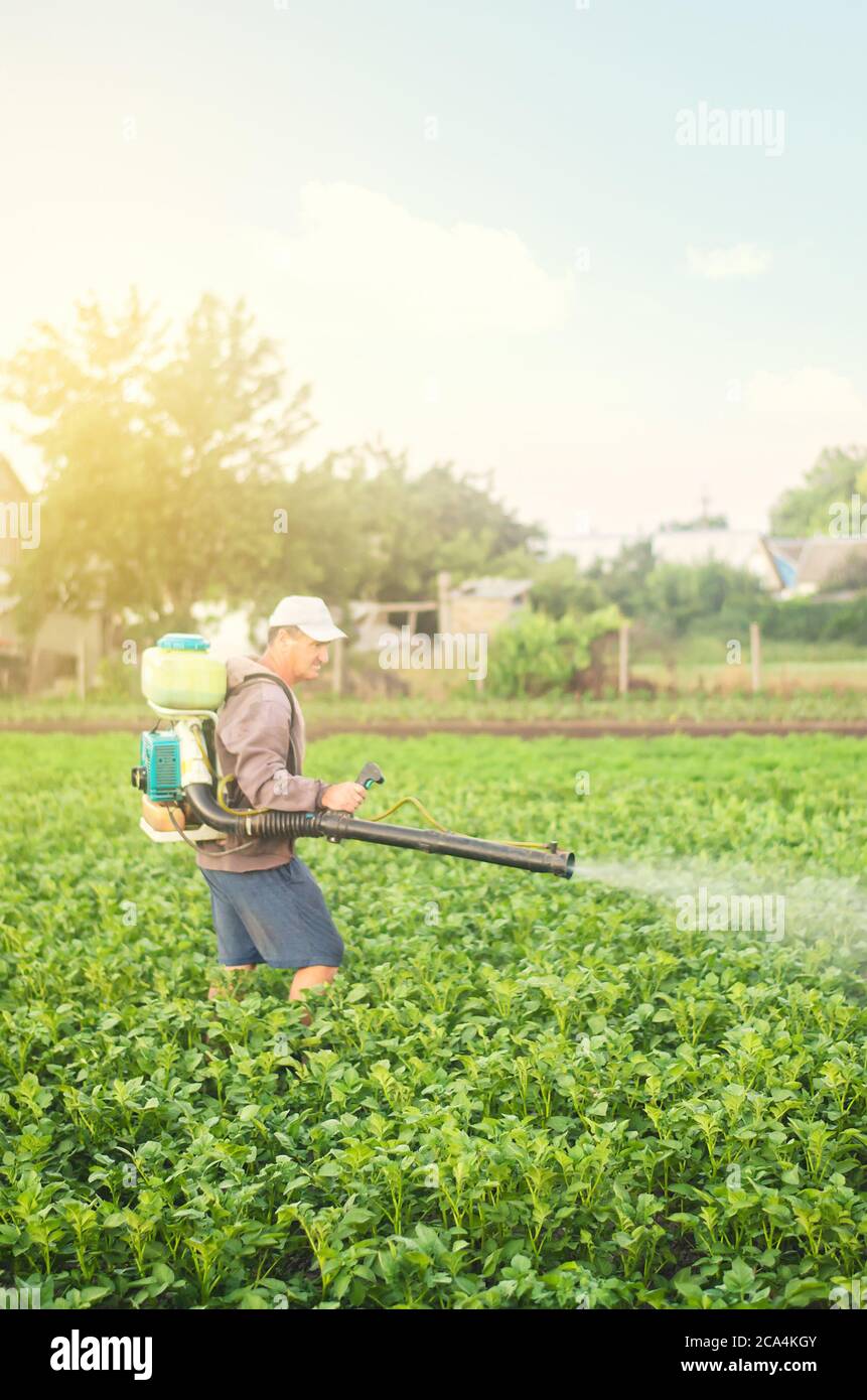 Farmer spraying potato field hi-res stock photography and images - Alamy