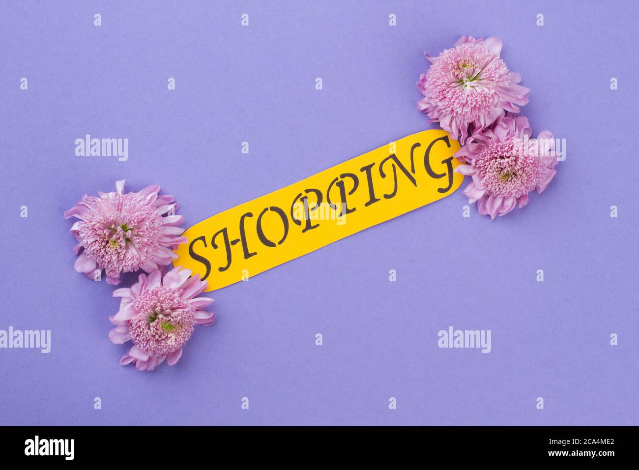 Word shopping and flowers isolated on purple background Stock Photo - Alamy