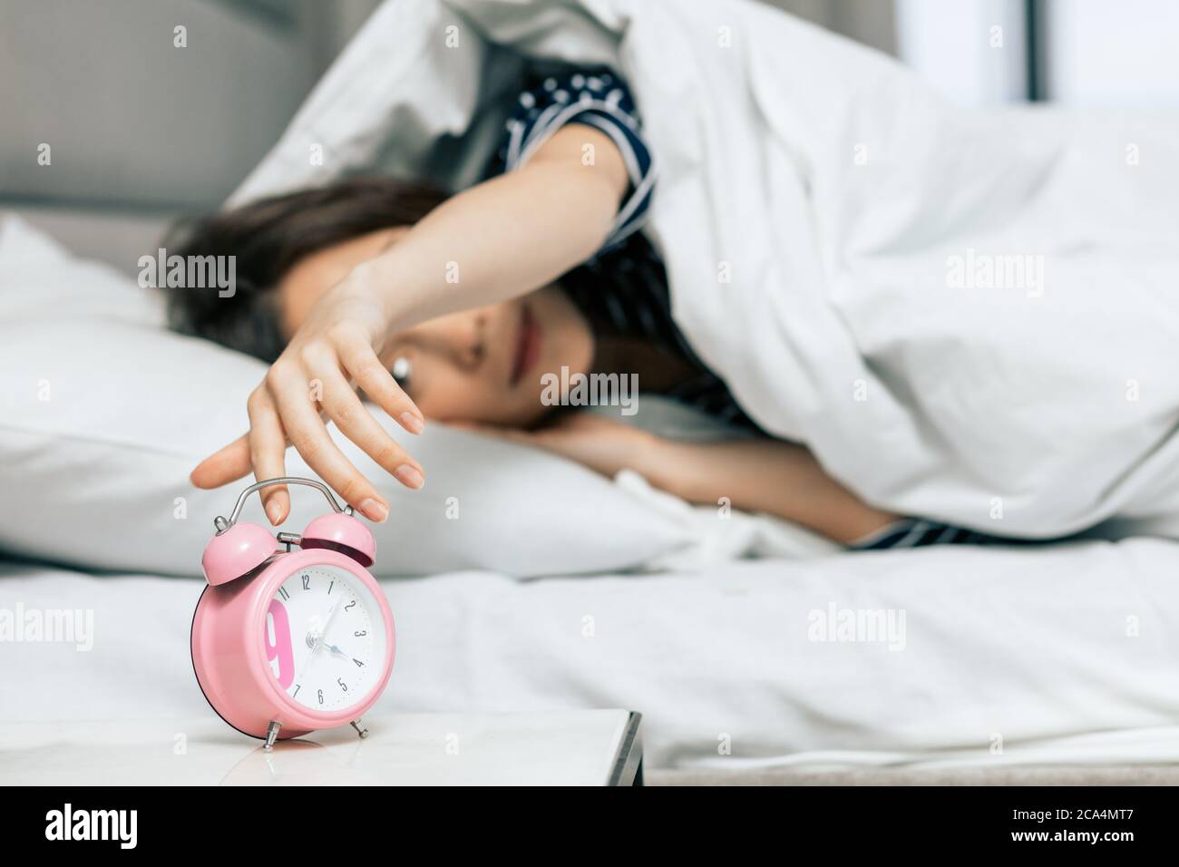 good looking girl turning off the clock. close up shot.. woman stopping ...