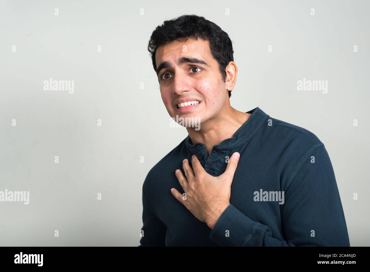 Portrait of stressed young Indian man looking scared Stock Photo - Alamy