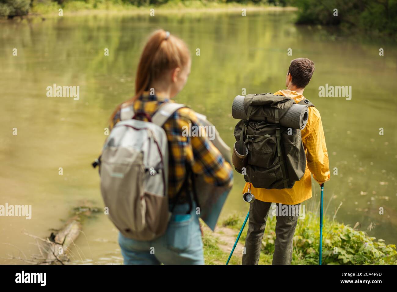two tourists walking on the forest, enjoying wonderful landscape. back ...