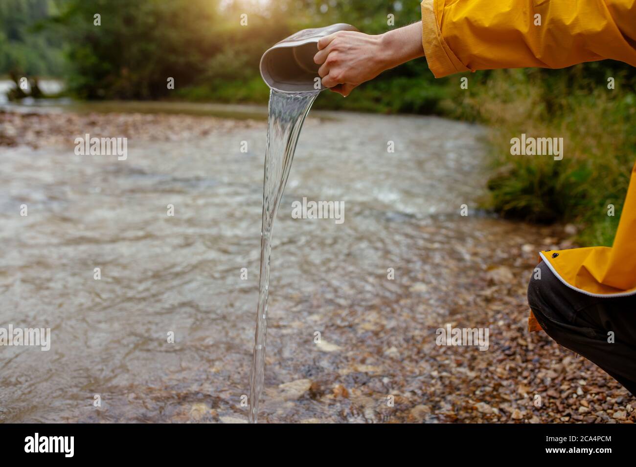 tourist pouring water to the river, close up cropped photo Stock Photo ...