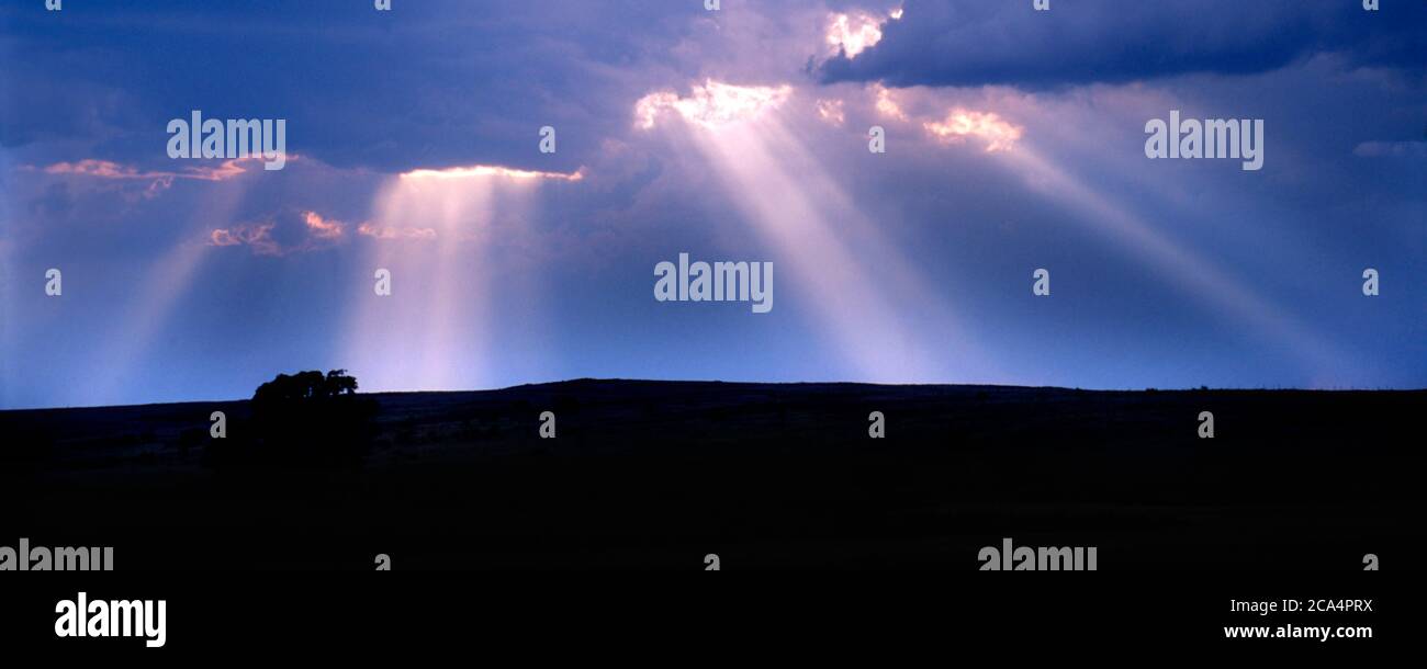 Sun shining through clouds Stock Photo - Alamy