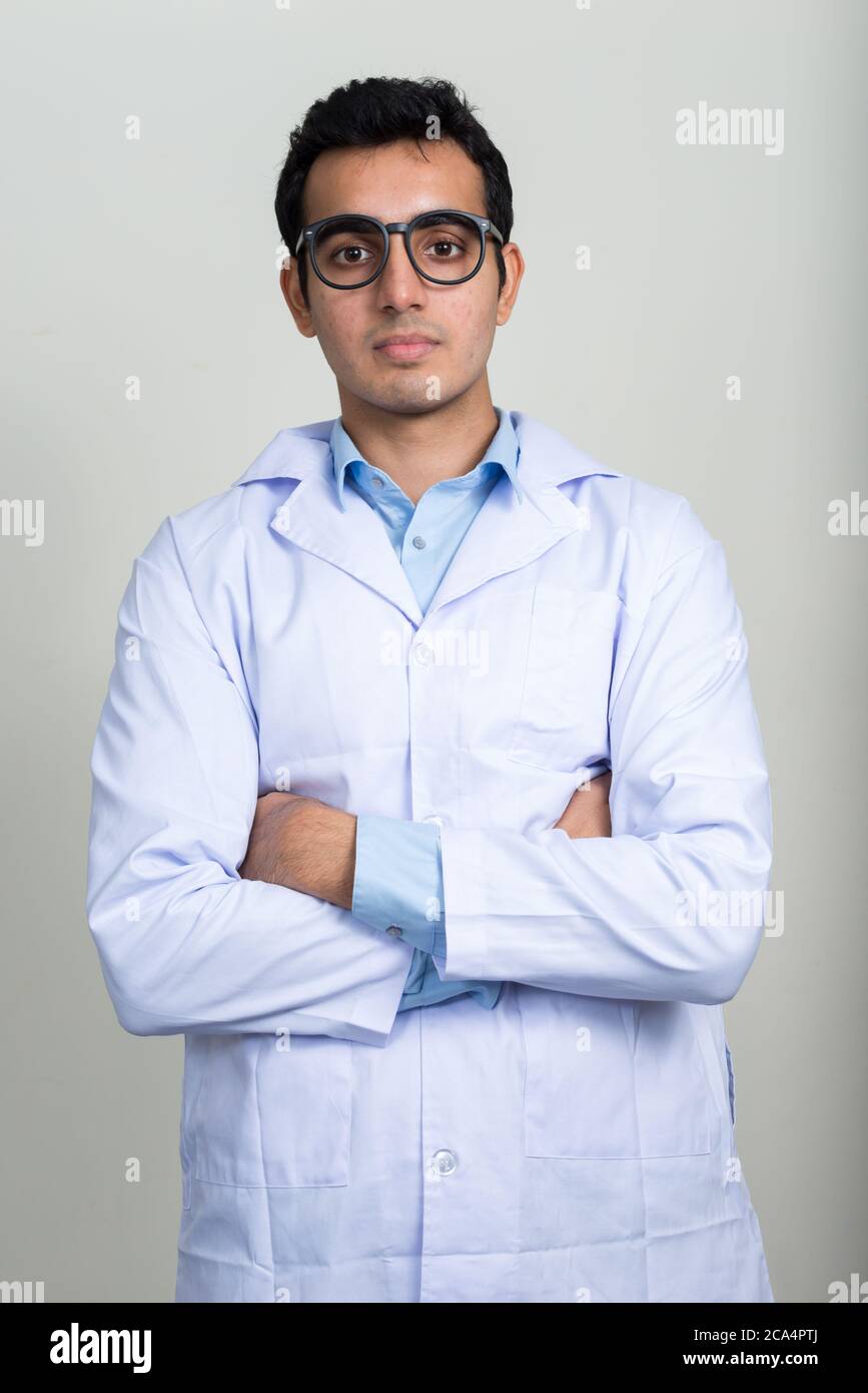 Portrait of young handsome Indian man doctor Stock Photo - Alamy