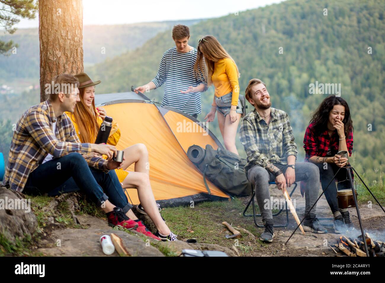 relaxed careless young people spending their weekend in the countriside ...
