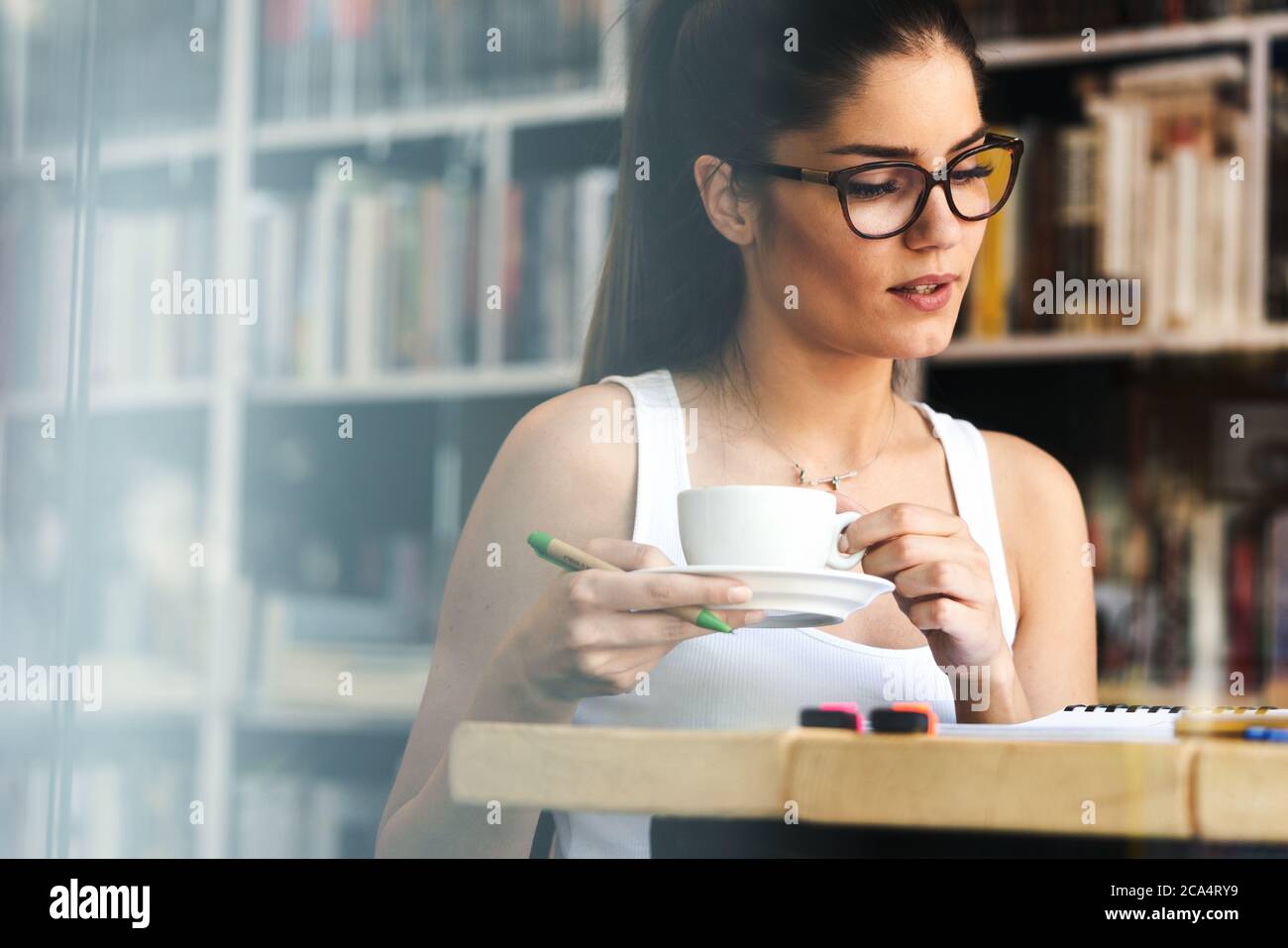 Young student studying with books hi-res stock photography and images ...