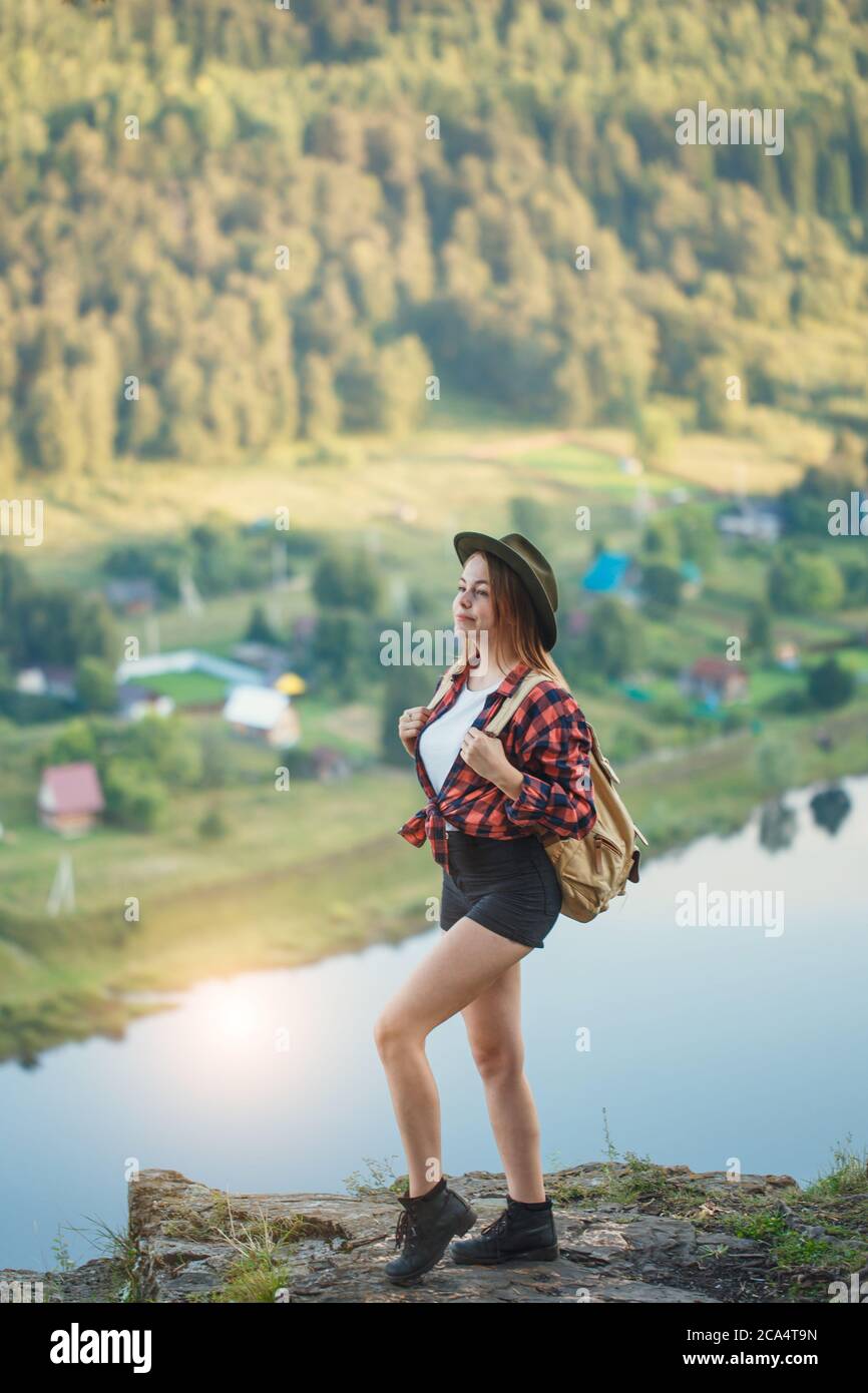 beautiful relaxed calm traveling woman standing on top of mountain at ...