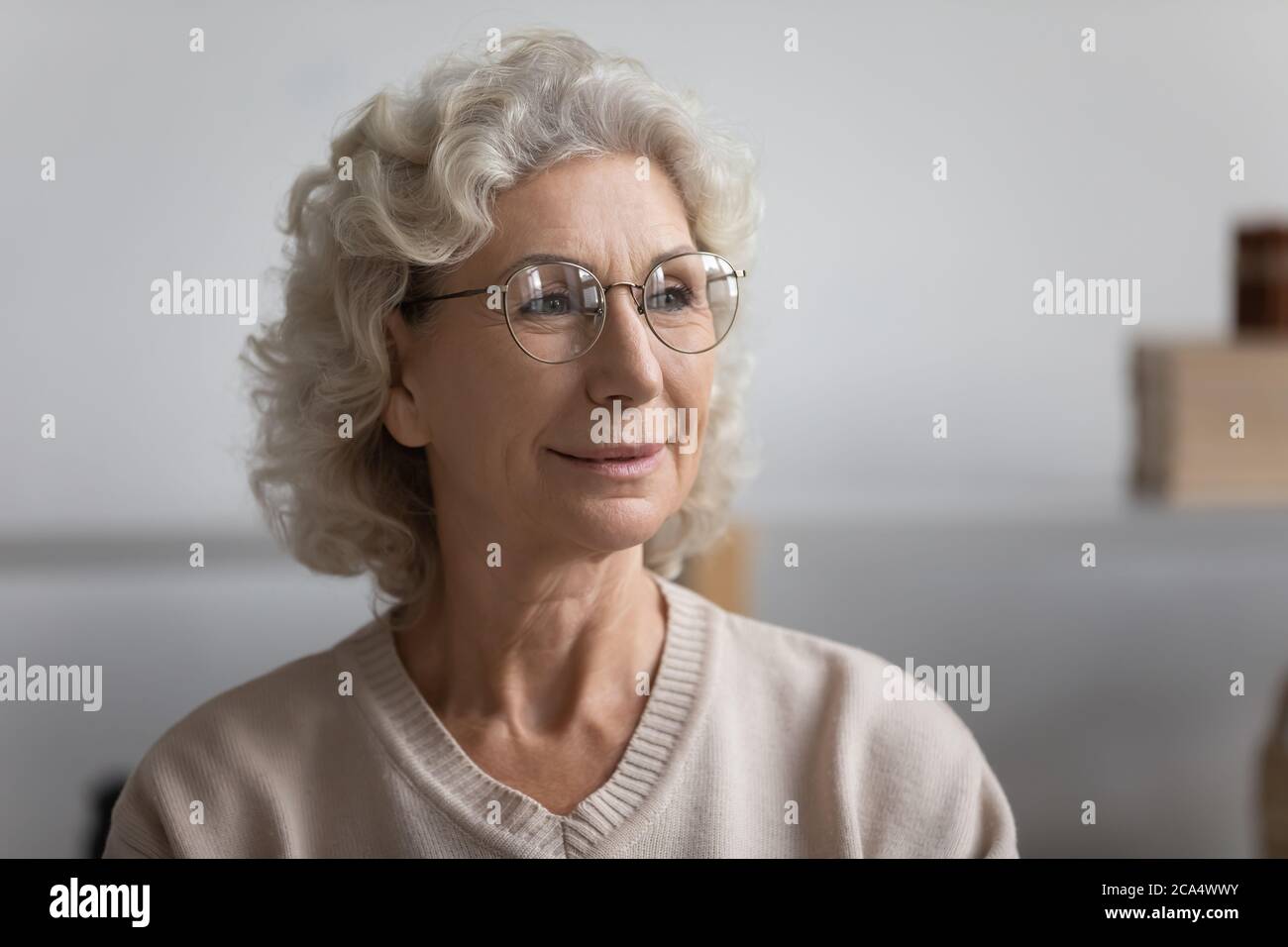Headshot portrait elderly woman in glasses look into distance Stock ...