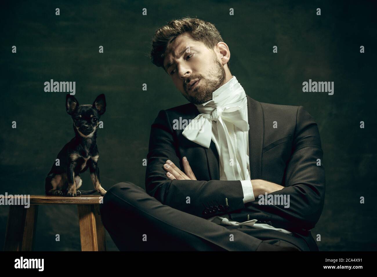 One friend. Young man in suit as Dorian Gray isolated on dark green ...