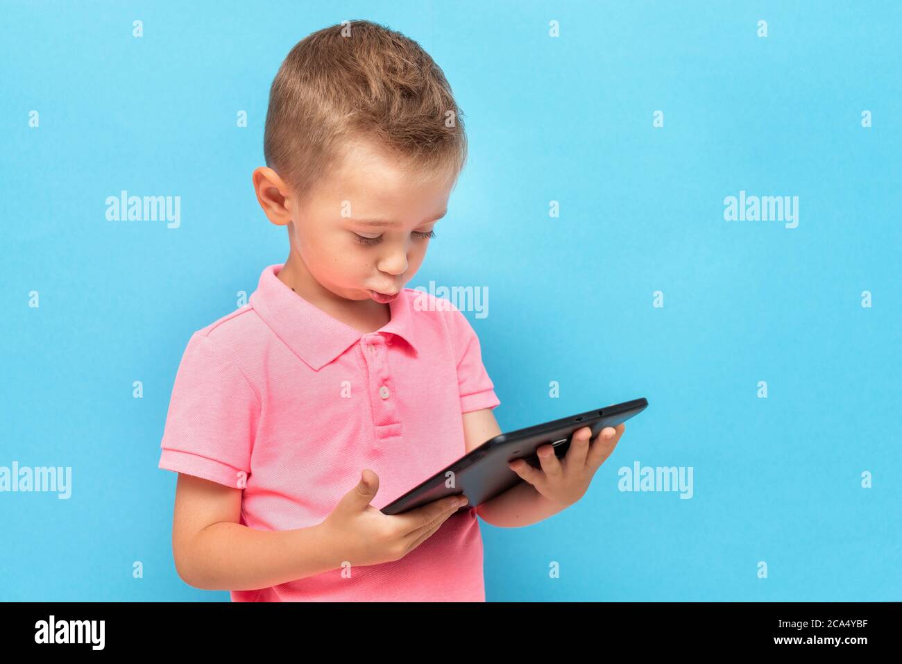 Toddler boy staring at tablet. Raising children concept Stock Photo - Alamy