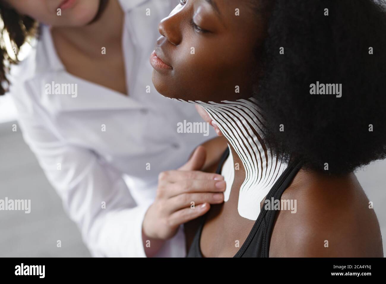 Woman taping neck hi-res stock photography and images - Alamy