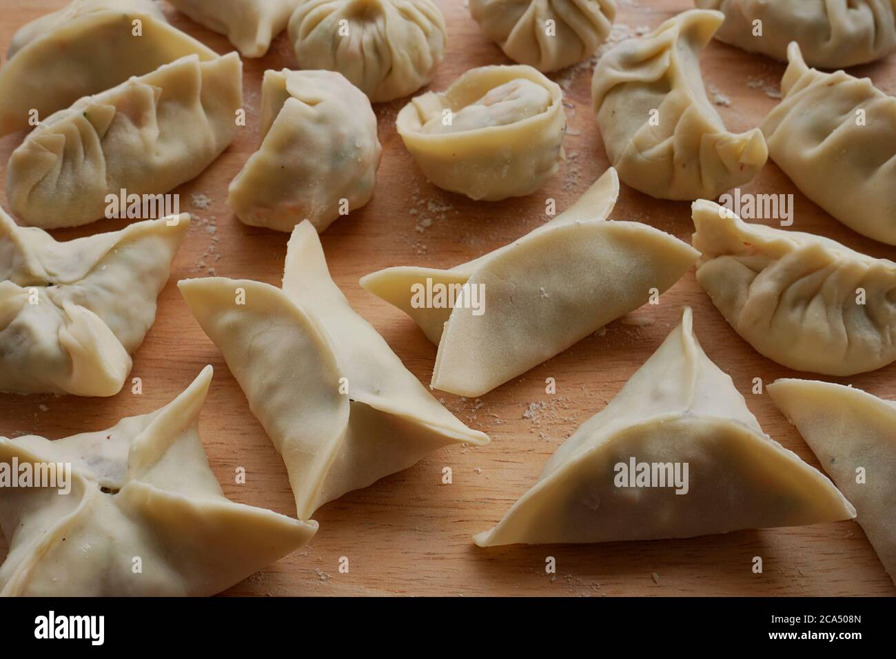 VEGETARIAN DIM SUM UNCOOKED WITH CHILLI OIL AND SCHEZWAN SAUCE Stock ...