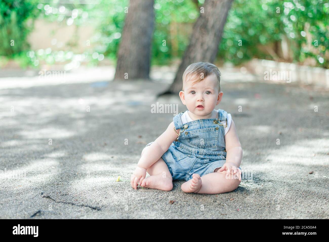 Baby girl playing in the backyard Stock Photo - Alamy