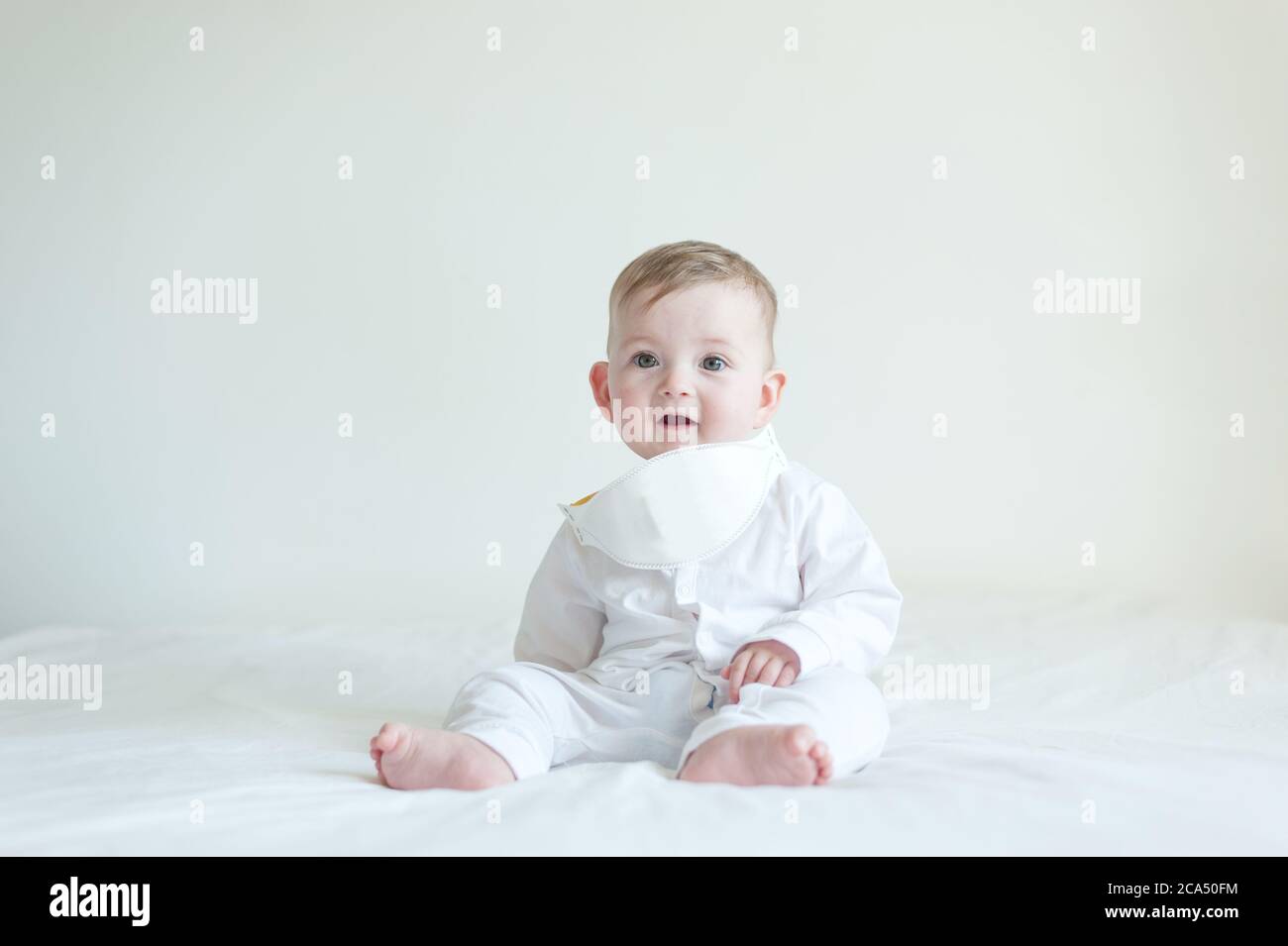 Baby girl wearing a mask white background Stock Photo - Alamy