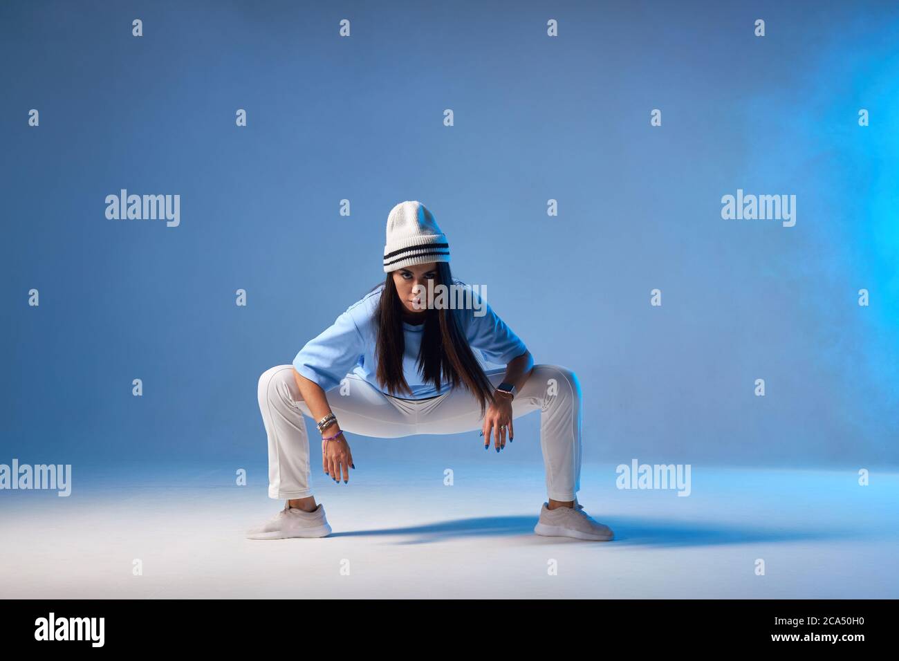 Attractive young dancer with long straight brunette hair, dressed in ...