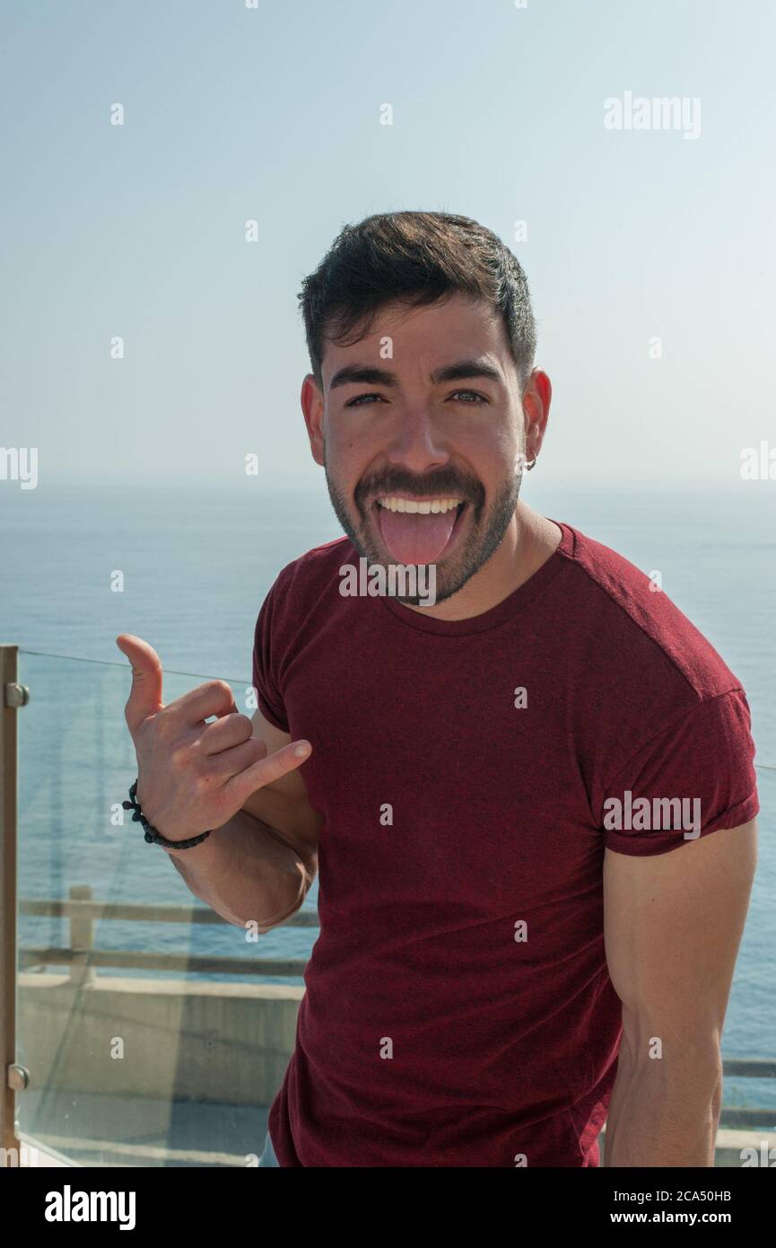 Young man portrait ocean background summer time Stock Photo - Alamy