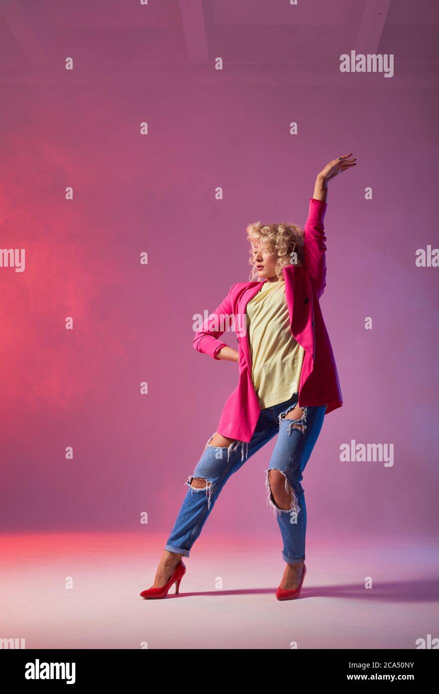 Beautiful cheerful woman dancing alone , expressing in full body ...