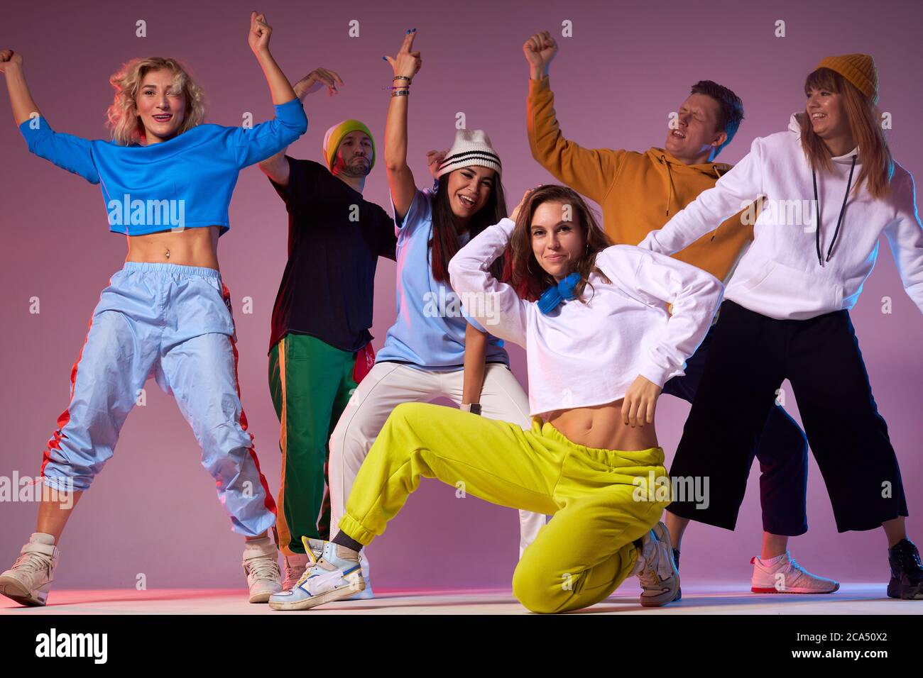 Young group of energetic teenagers dancing with soul, demonstrating ...