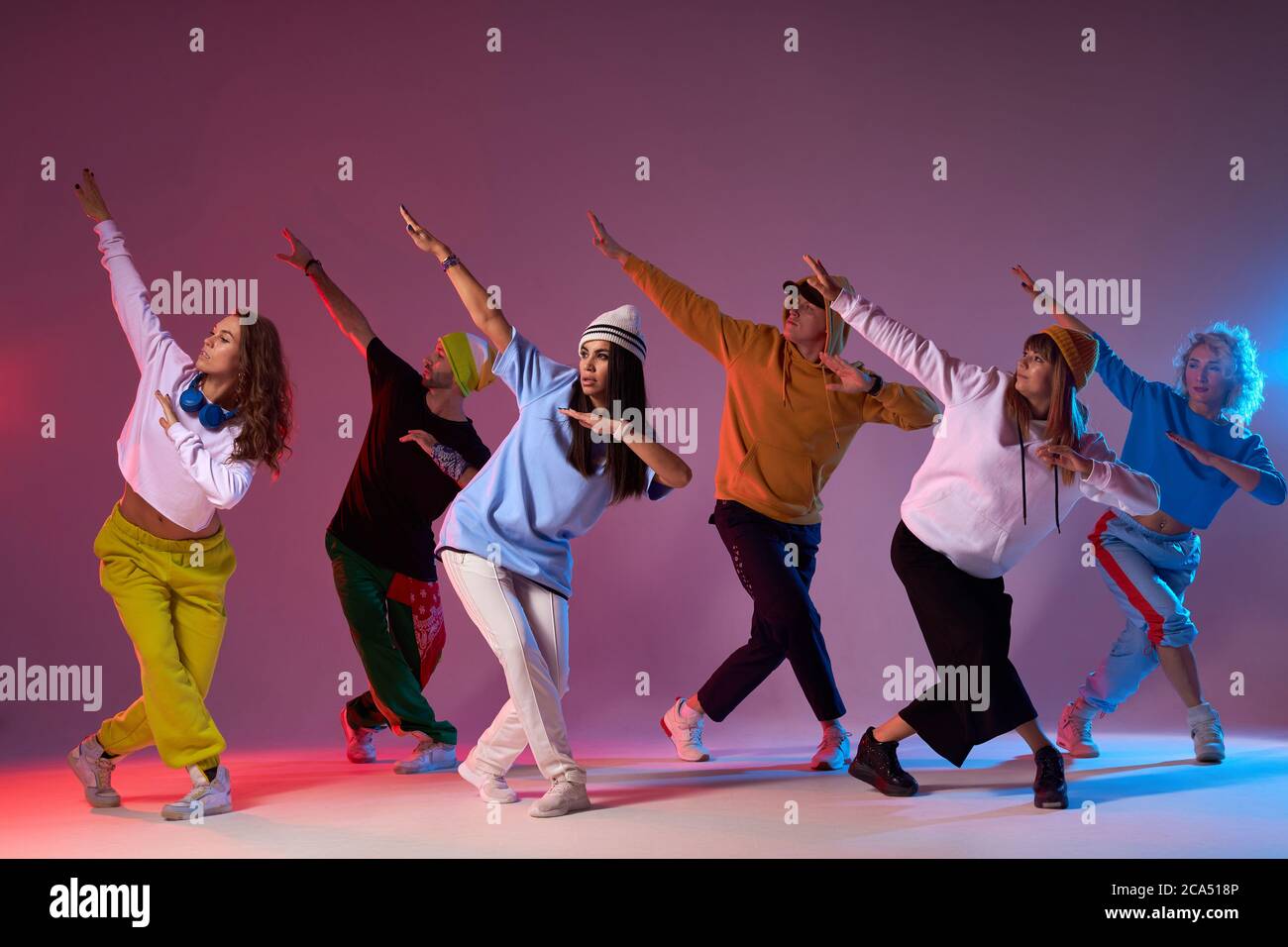 Modern dancers posing in front of studio background, performing modern ...