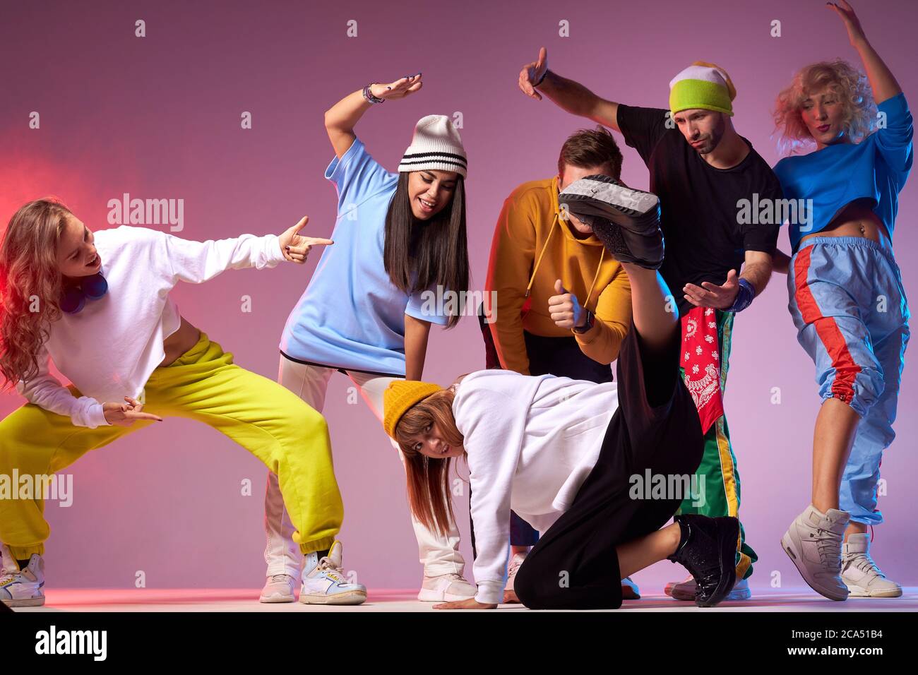 Hip hop battle in spacious dance hall, young people dancing break dance ...