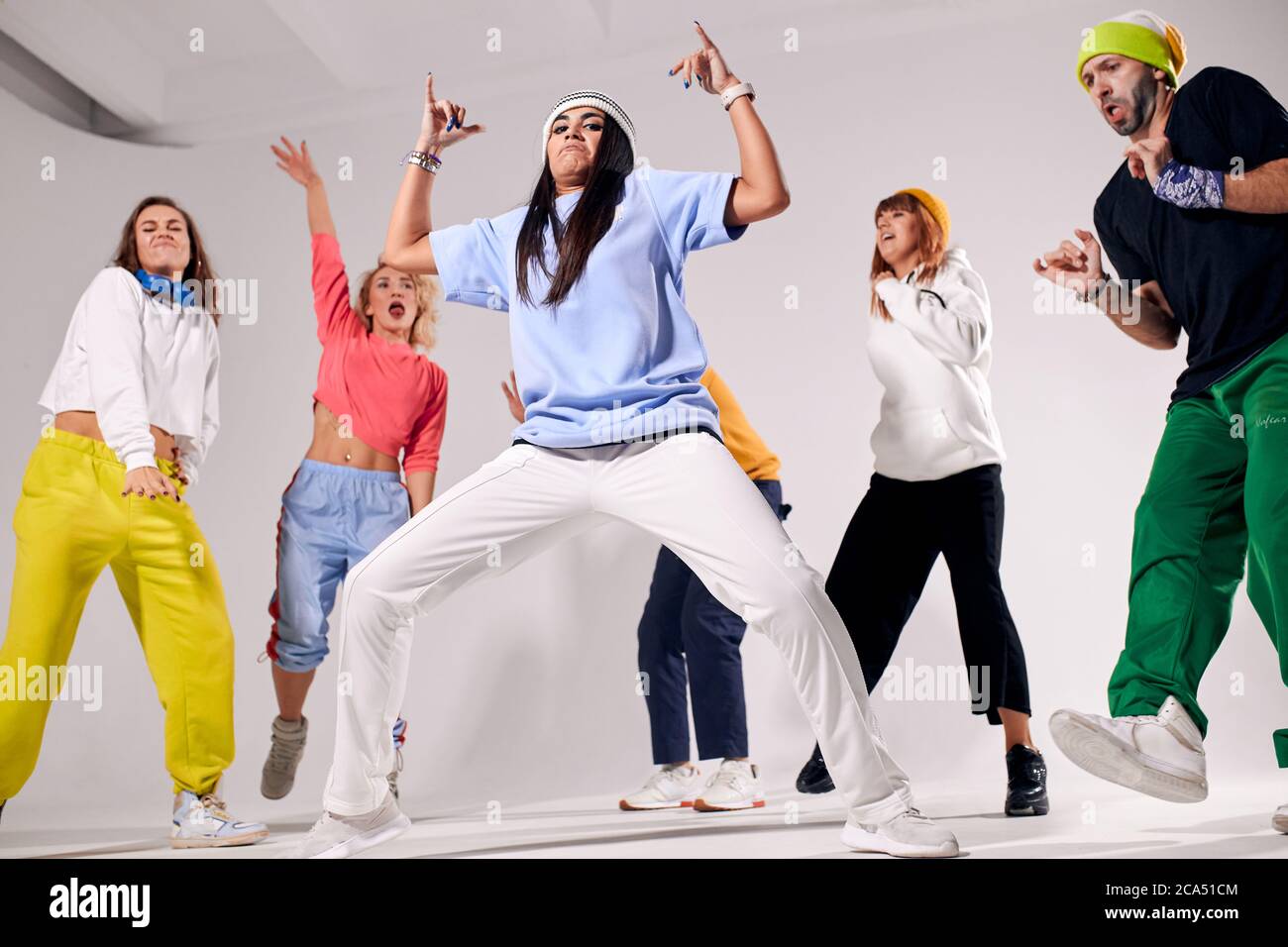 Cool teenagers spending great time on hip hop party, standing in full ...