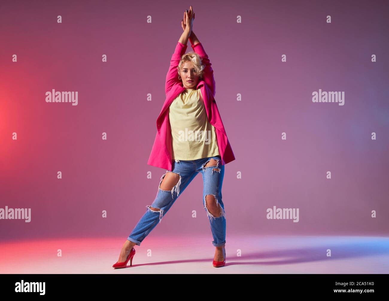 Cheerful active sporty dancer dressed in bright colourful clothes ...