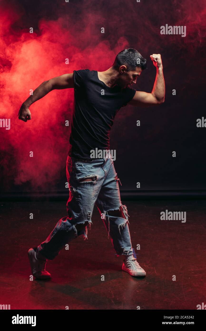 process of dancing of young male isolated in studio, acrobatic ...
