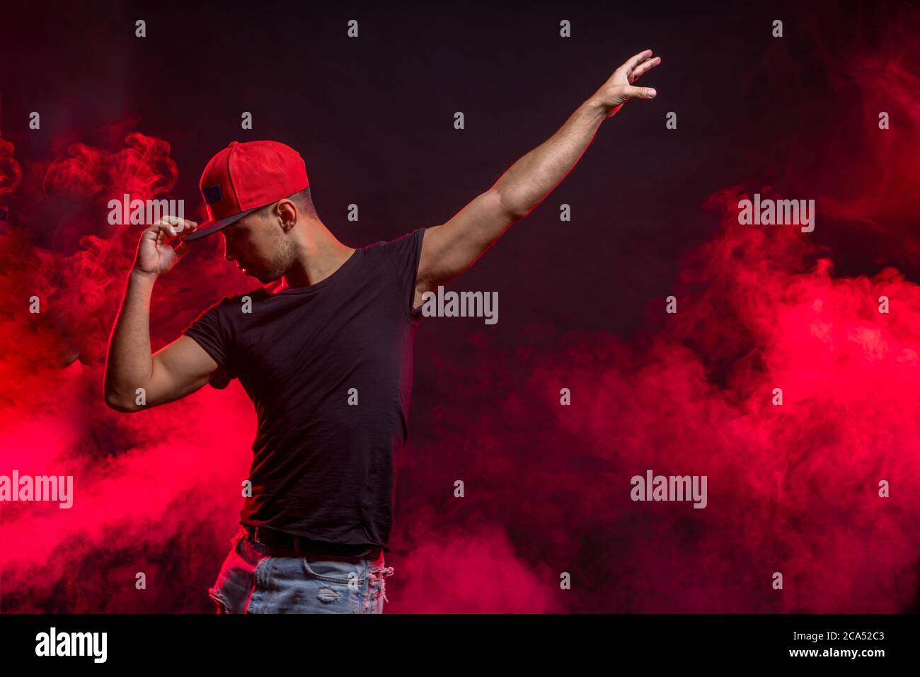 professional male dancer dancing isolated over smoky background, with ...