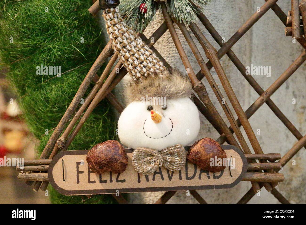 Christmas decoration. Snowman figure with a sign where we can read ...
