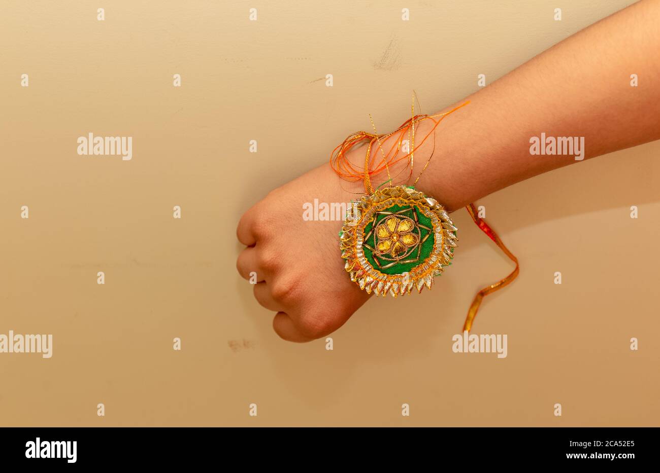 Crop view of Girl hand tying knot of Rakhi to her brother during the ...