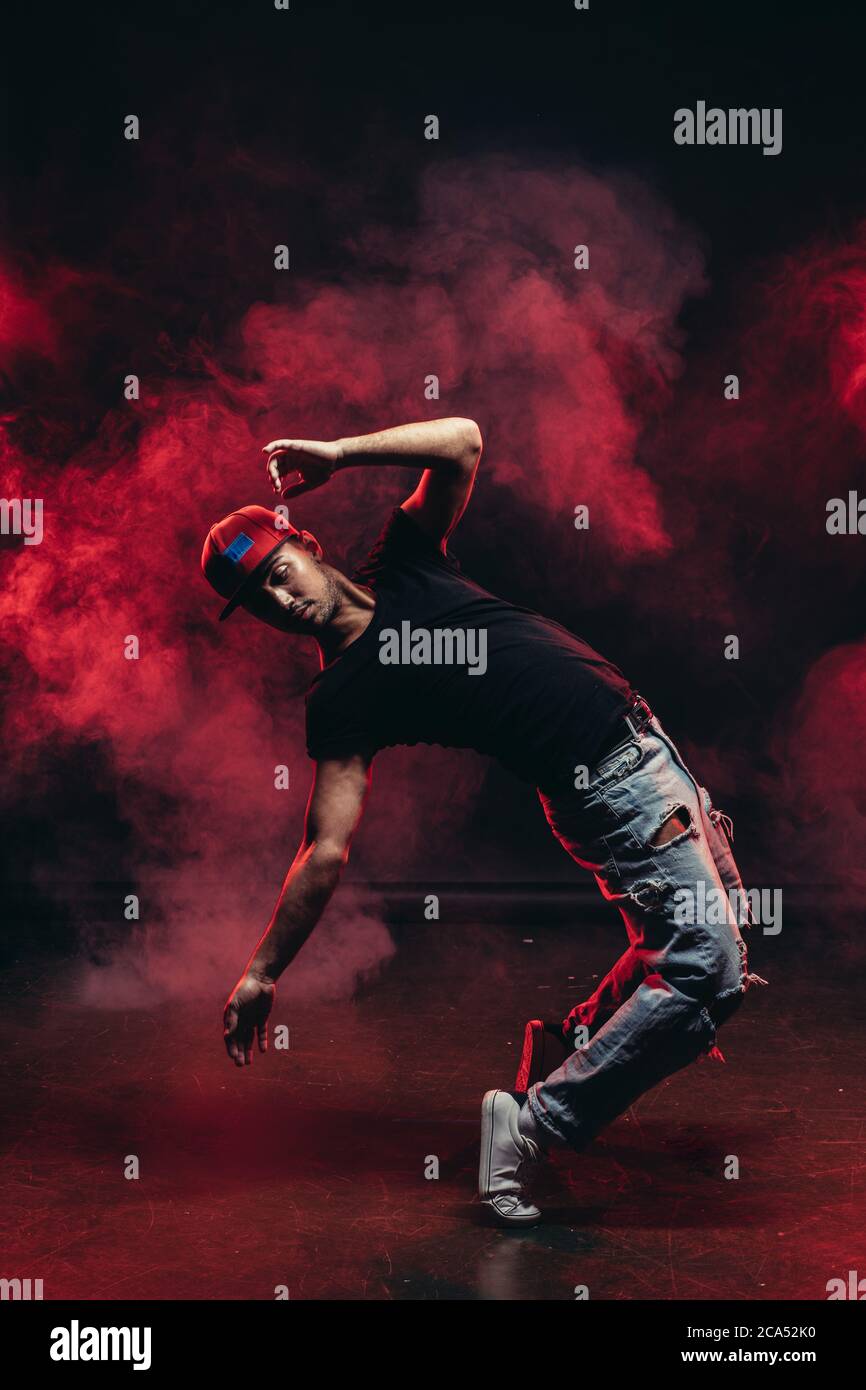 process of dancing of young male isolated in studio, acrobatic ...