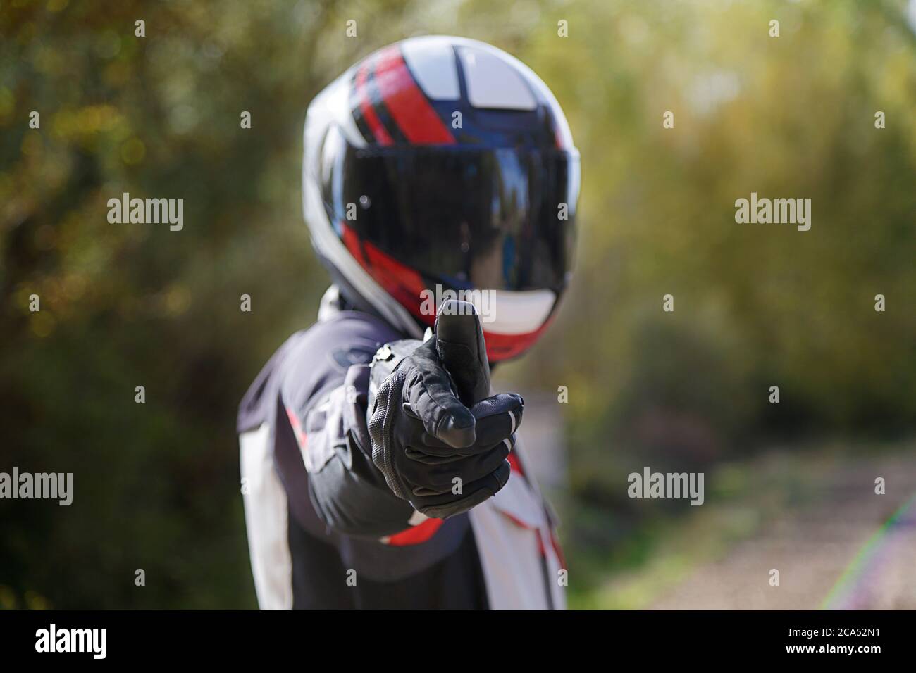 Biker pointing his finger at you. Soft focus background Stock Photo - Alamy