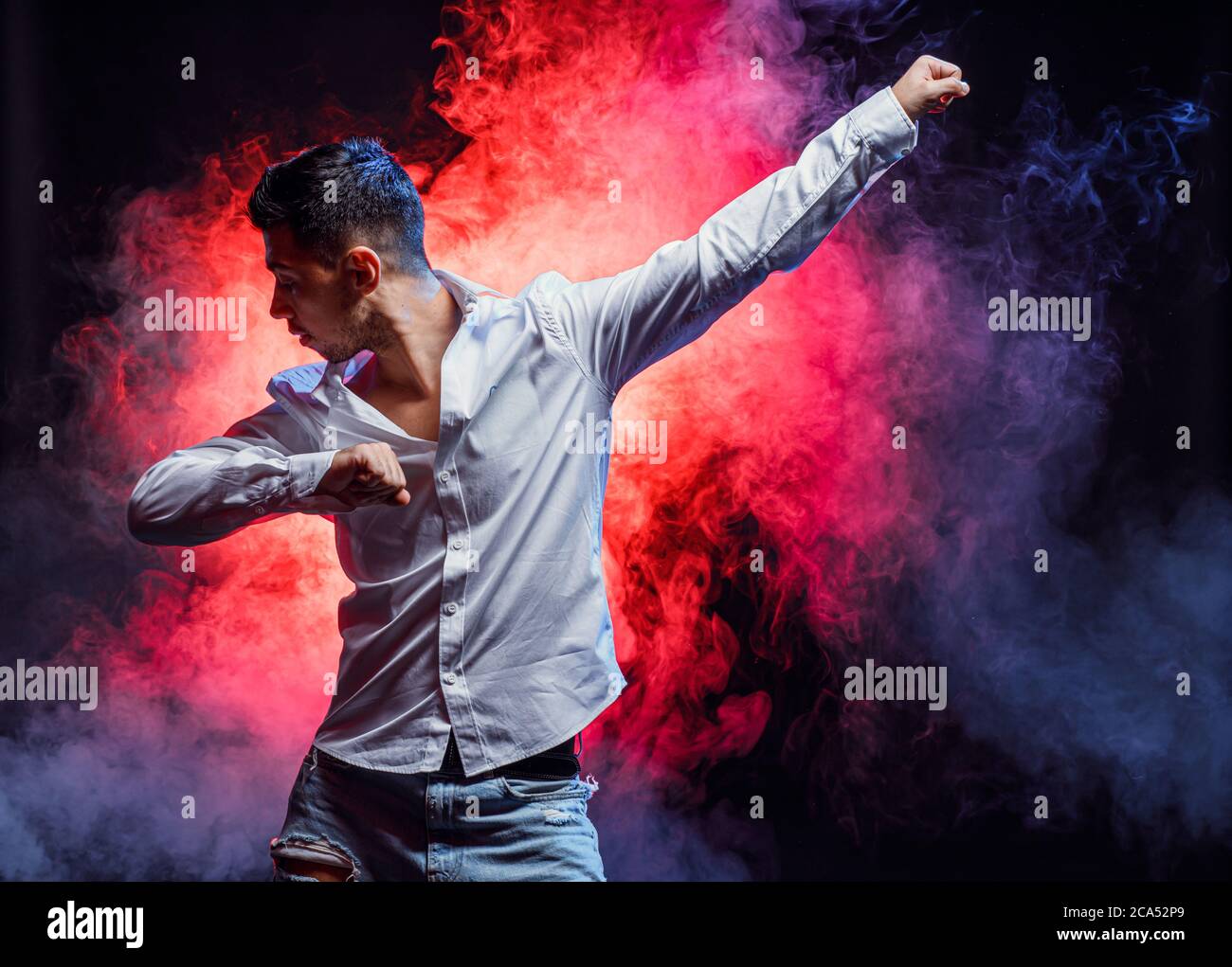 professional male dancer dancing isolated over smoky background, with ...