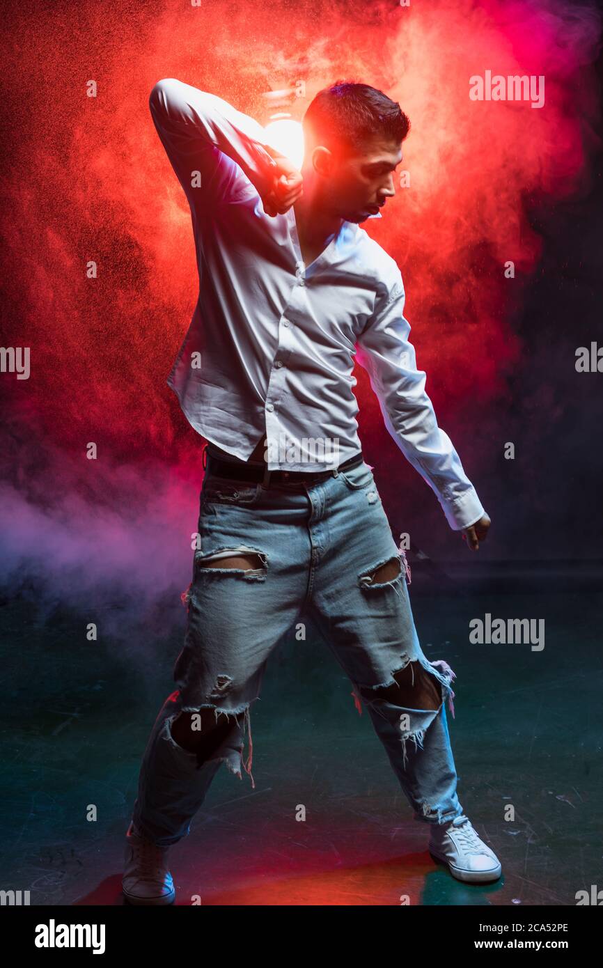 portrait of dancing man performing street dance or hip-hop, modern ...