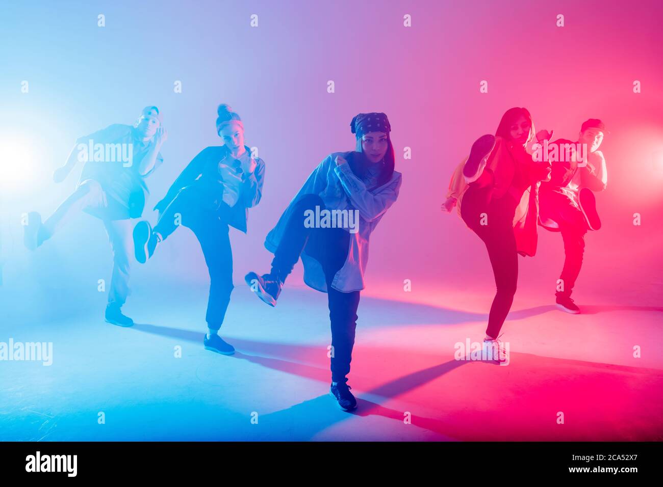 Young modern dancing group of six adult young people practice dancing ...