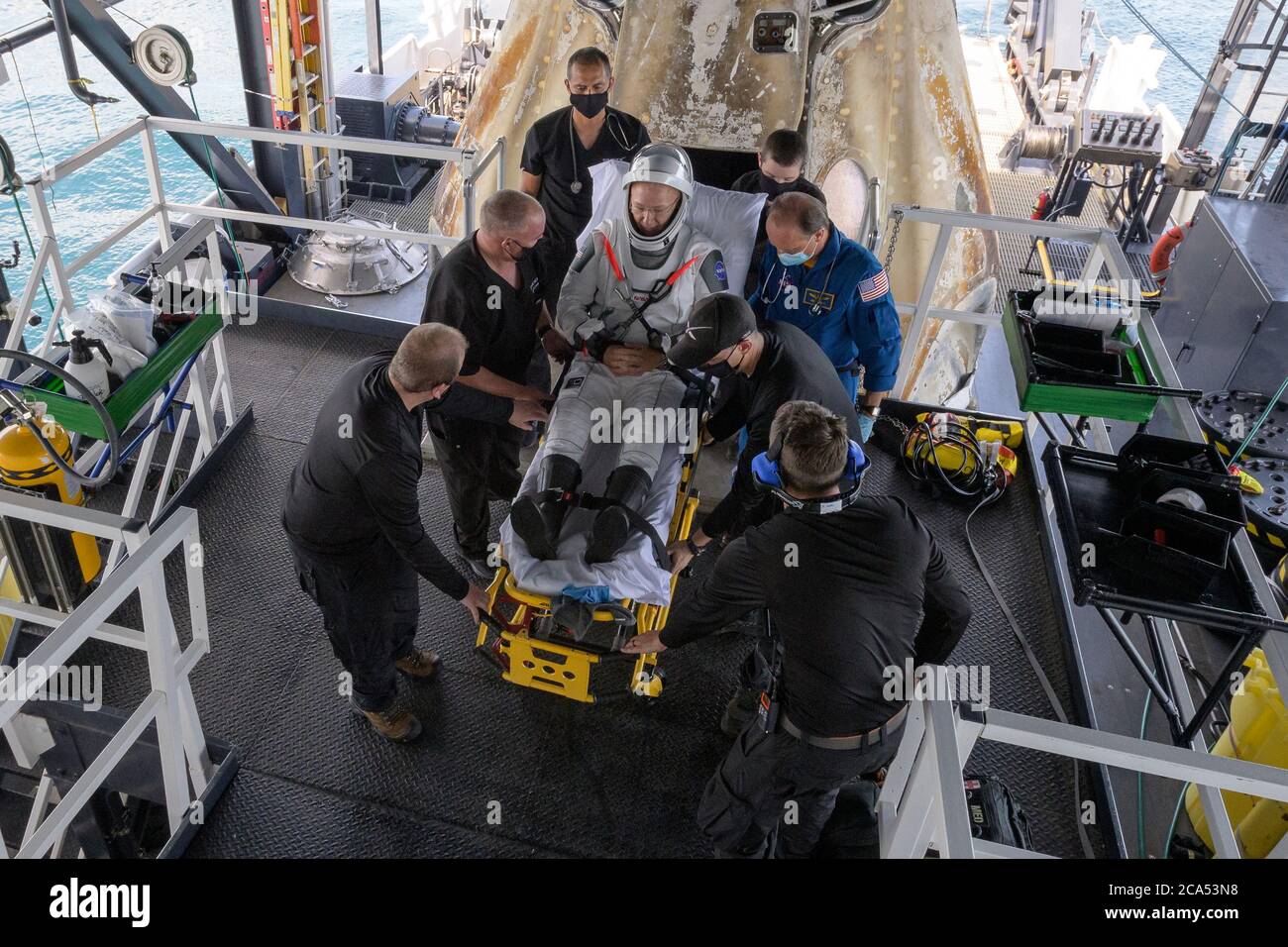 NASA astronaut Douglas Hurley is helped out of the SpaceX Crew Dragon ...