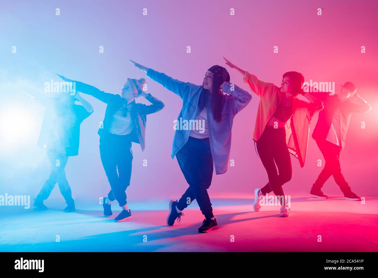 Young modern dancing group of six adult young people practice dancing ...