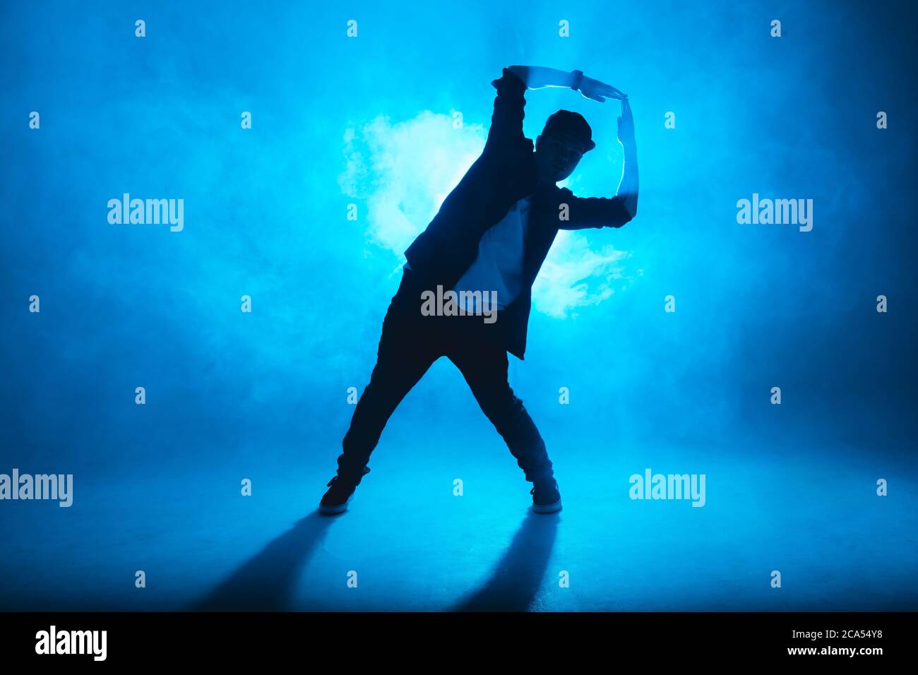 Stylish young man wearing trendy streetwear is dancing contemporary ...