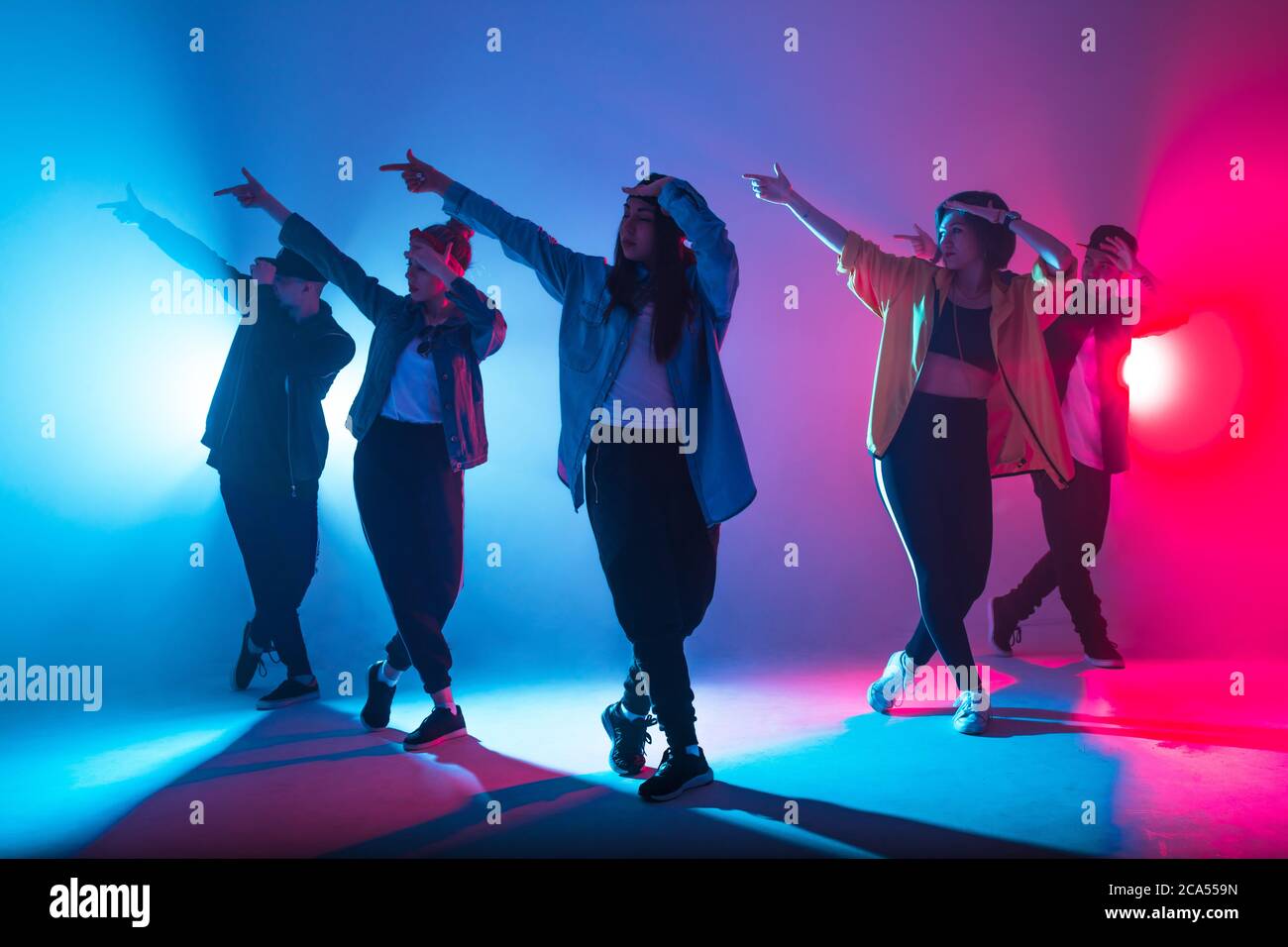 Young modern dancing group of six adult young people practice dancing ...