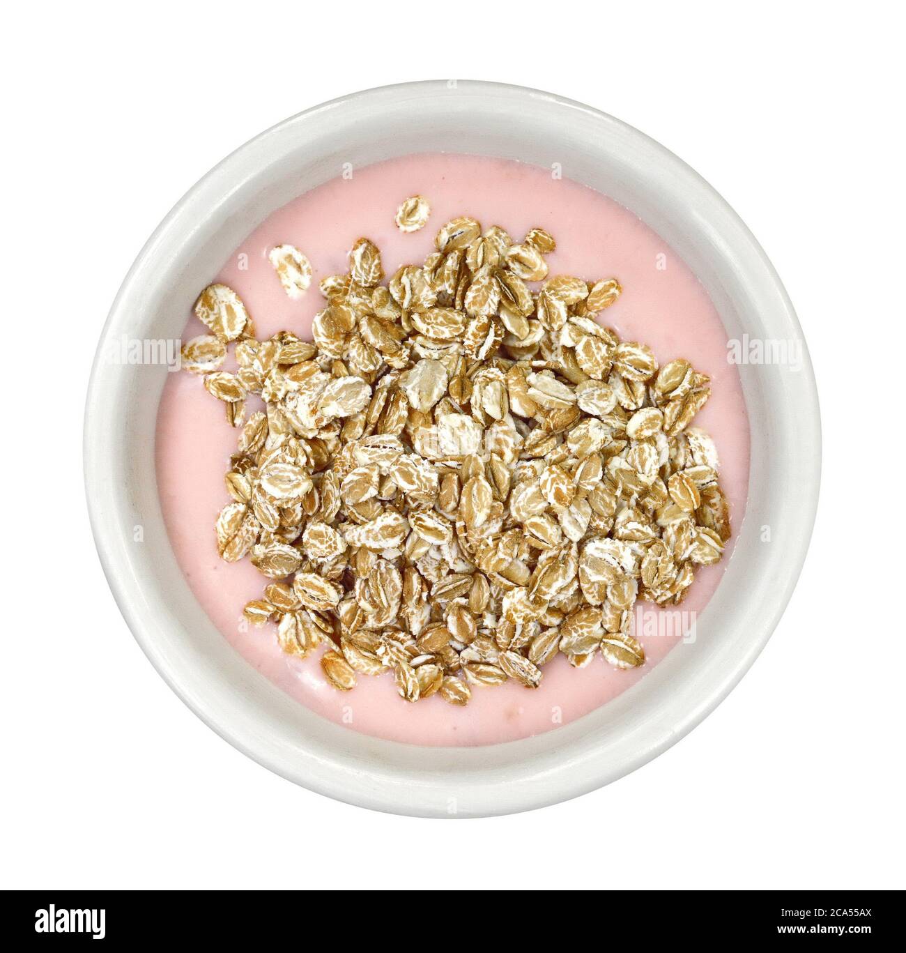 Ceramic bowl of fruit yogurt with rye oat flakes isolated on white ...
