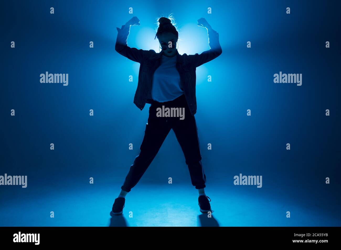 Stylish woman dancing solo on hip hop party. Sunglasses, modern black ...