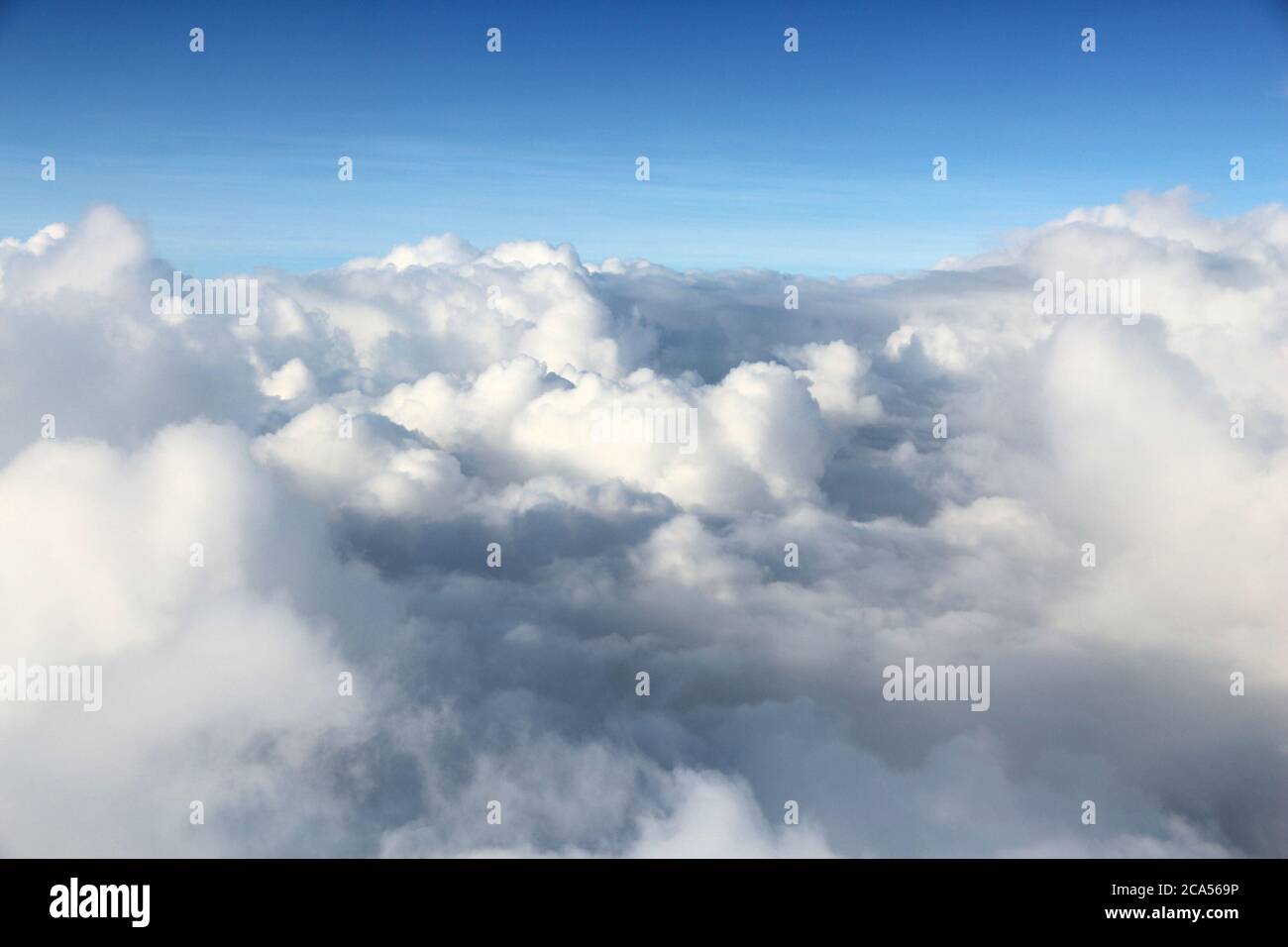 Fluffy clouds aerial view. White cumulus clouds sky plane window view ...